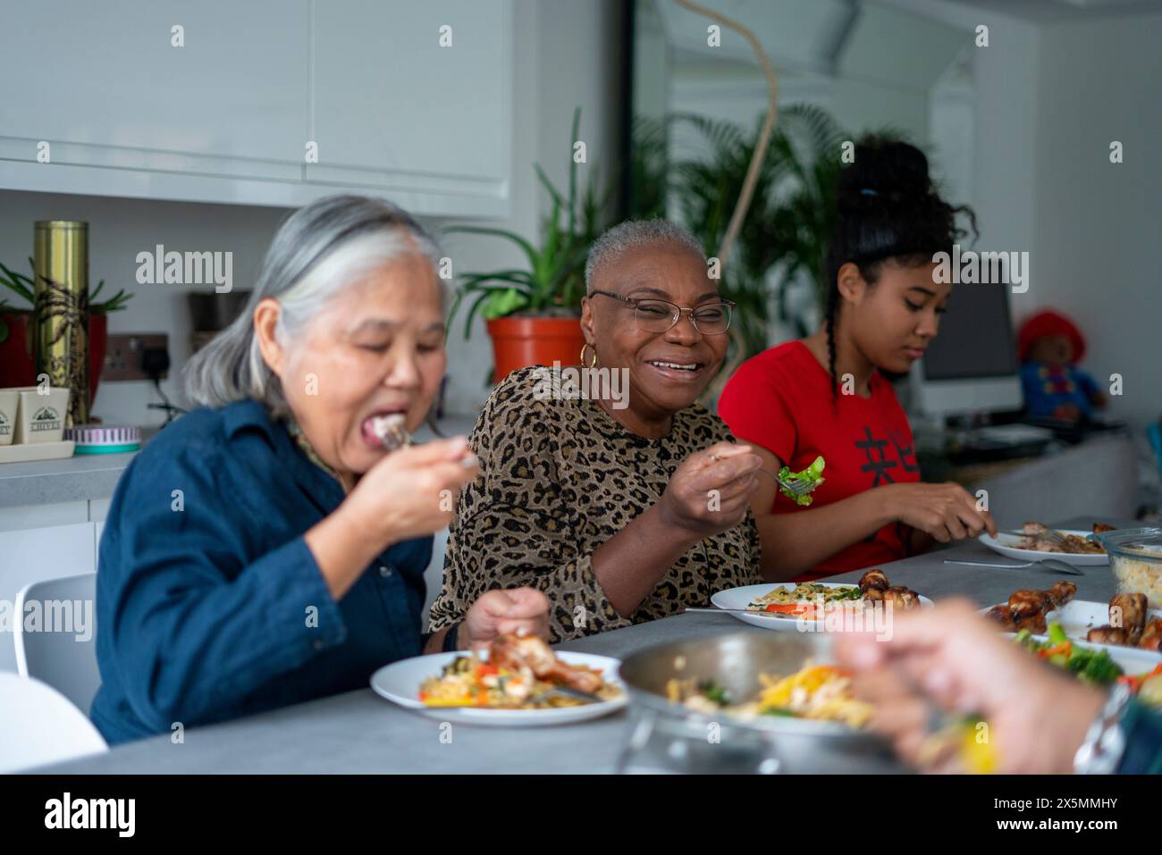 Family eating dinner together Stock Photo - Alamy