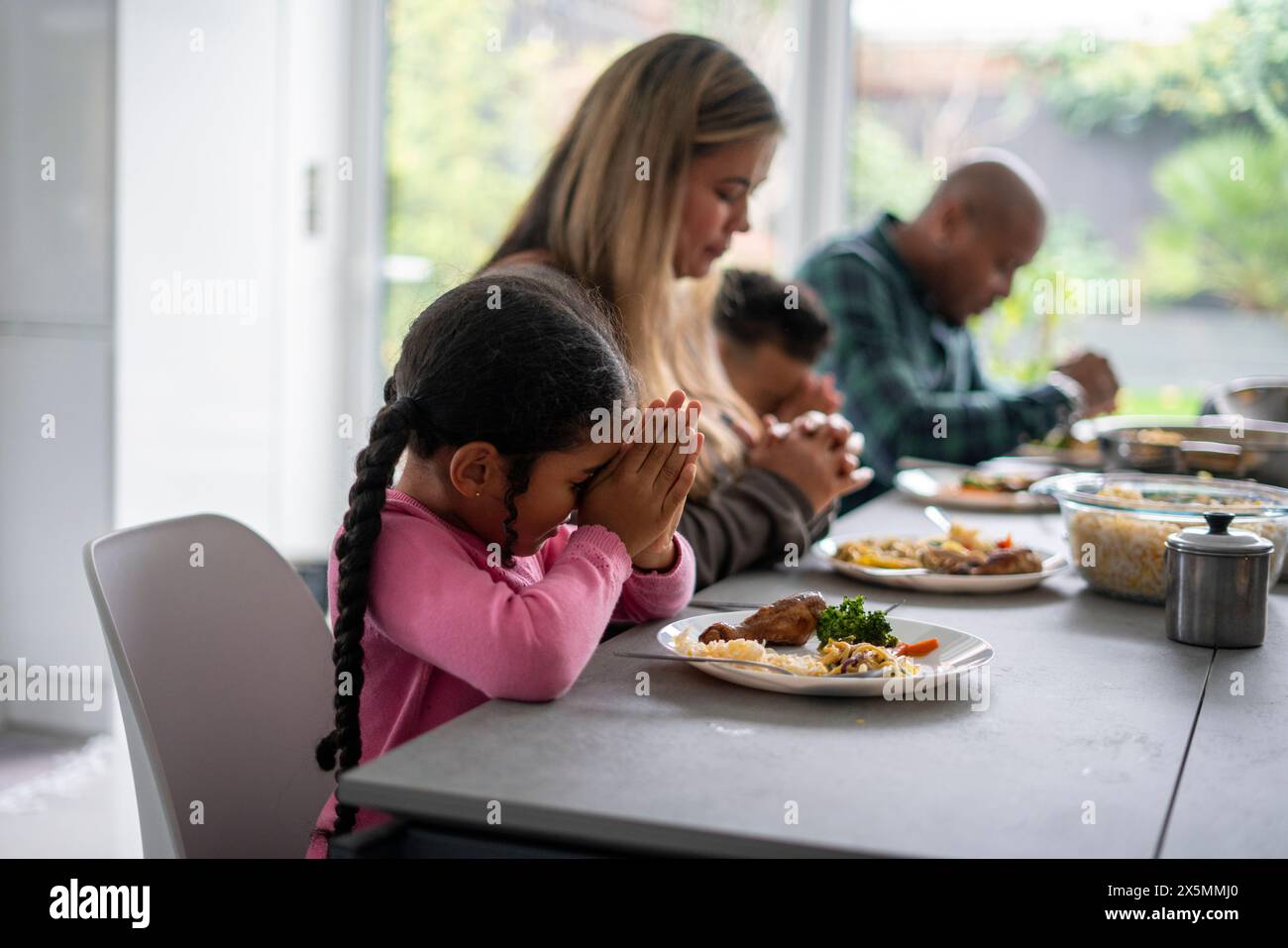 Family praying dining table hi-res stock photography and images - Alamy