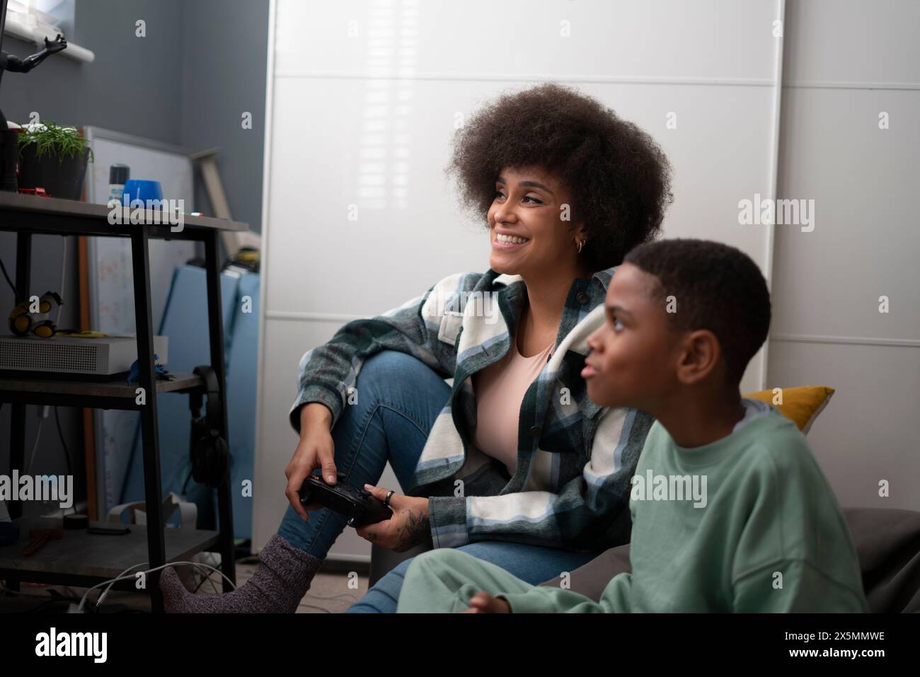 Mother and son playing video games at home Stock Photo - Alamy