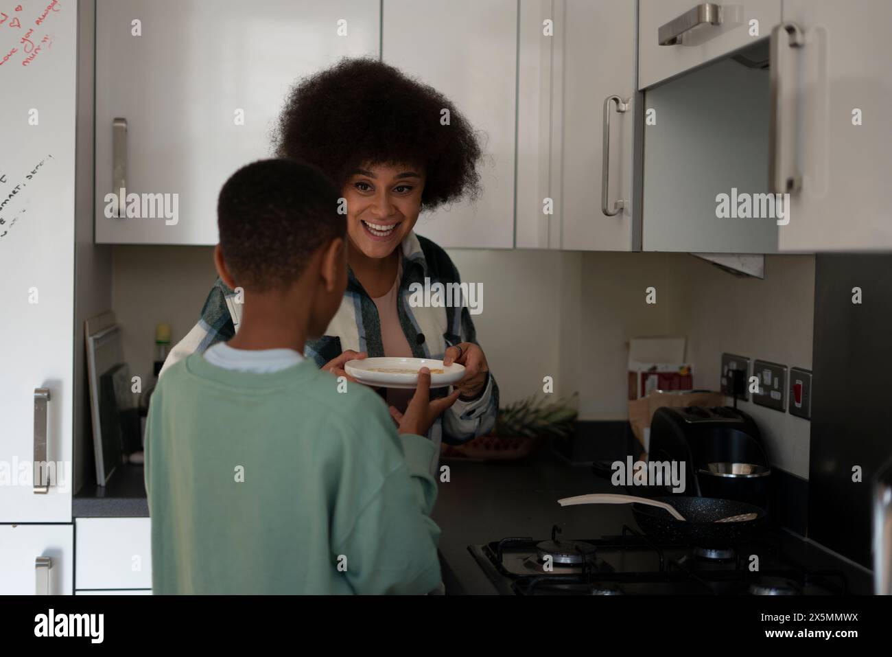 Mother and son cooking in kitchen Stock Photo - Alamy