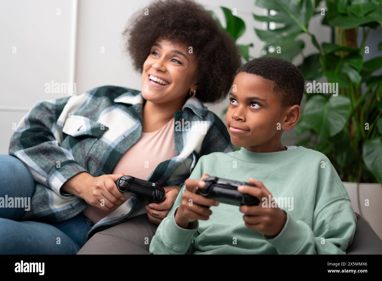 Mother and son playing video games at home Stock Photo - Alamy