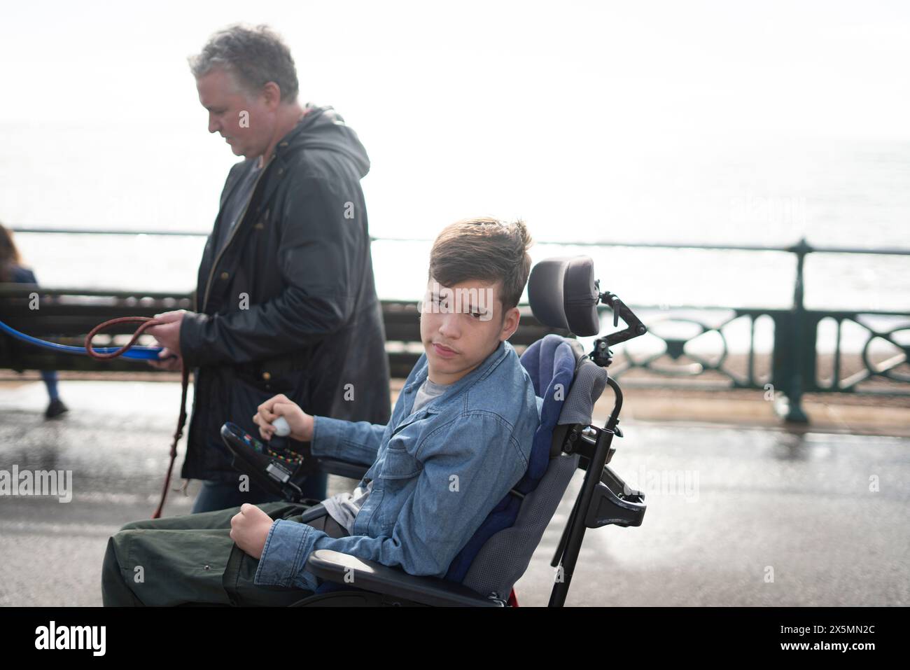 Father and disabled son strolling on promenade Stock Photo - Alamy