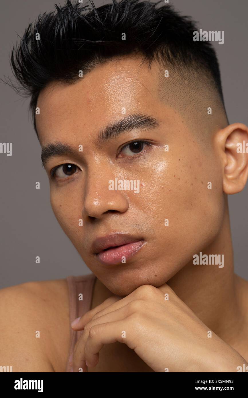 Studio portrait of pensive person Stock Photo - Alamy