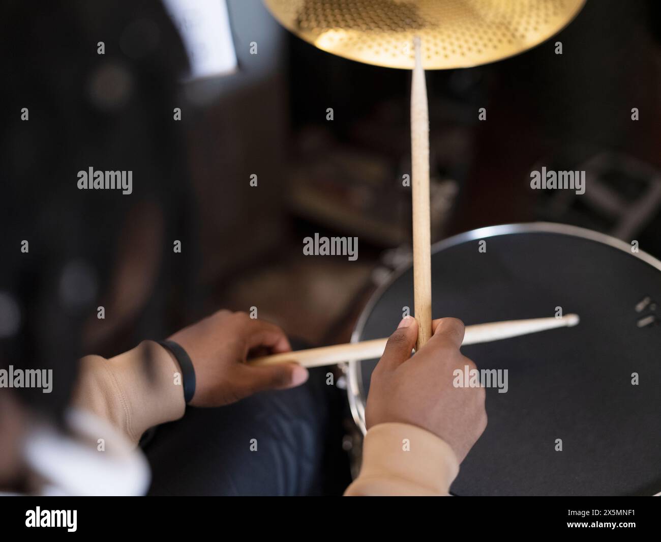 Teenage boy practicing playing drums Stock Photo - Alamy