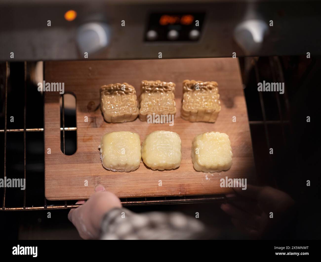 Woman putting baking sheet hi-res stock photography and images - Alamy