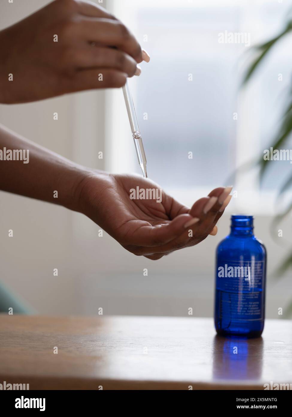 Close-up of womans hands holding pipette with facial serum Stock Photo ...