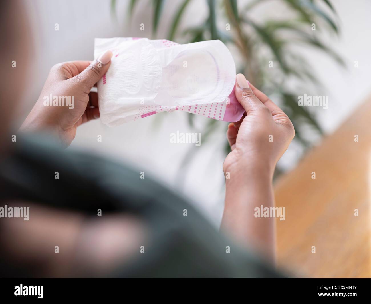 Close-up of womans hand unfolding sanitary pad Stock Photo - Alamy