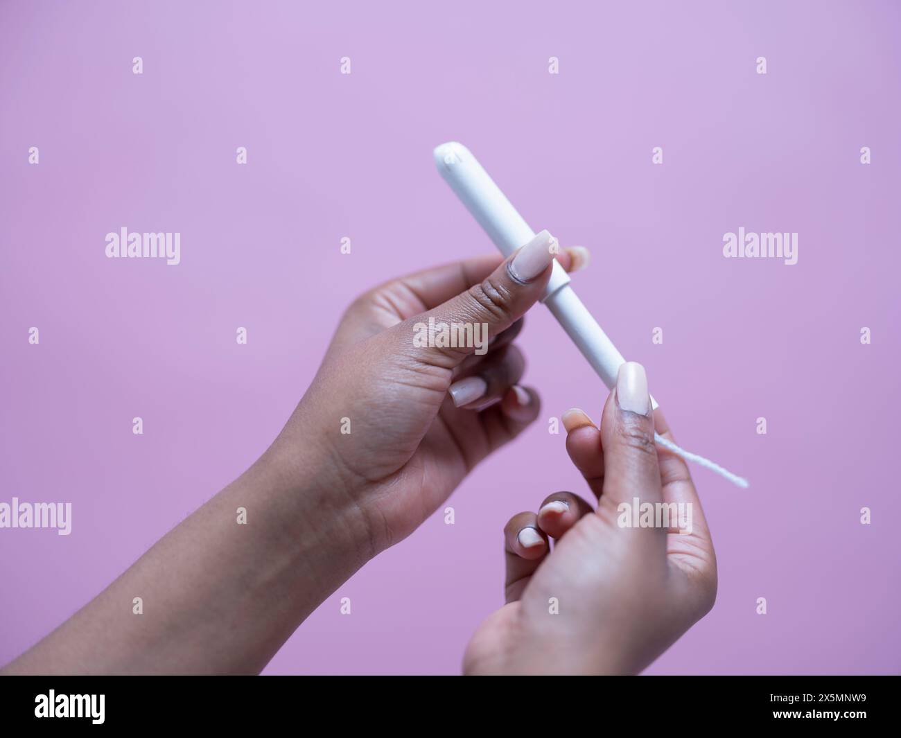 Close-up of womans hands holding tampon Stock Photo - Alamy