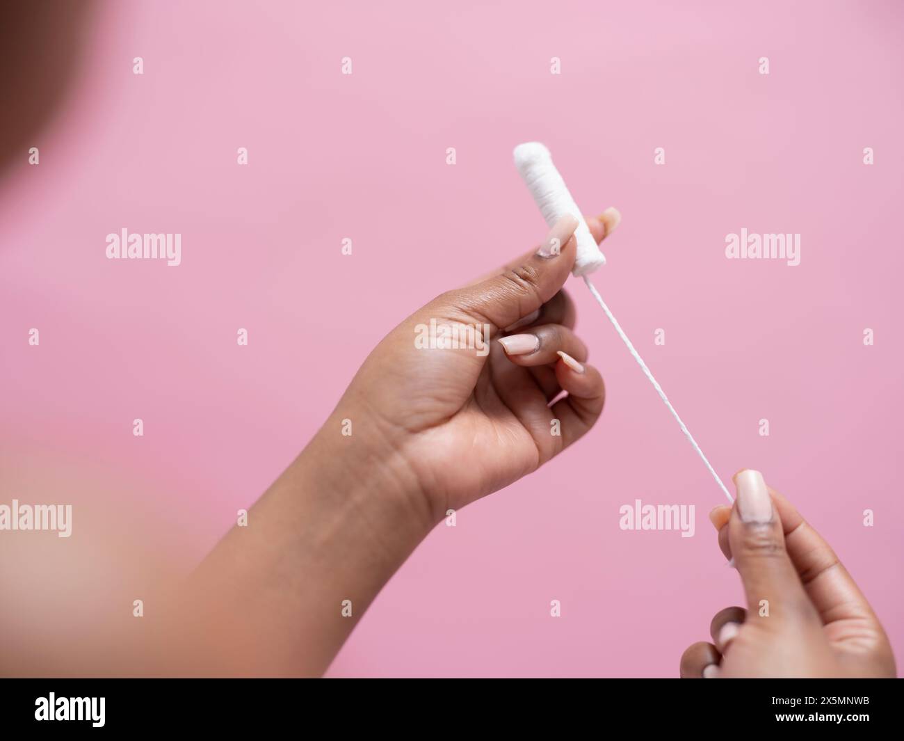 Close-up of womans hands holding tampon Stock Photo - Alamy