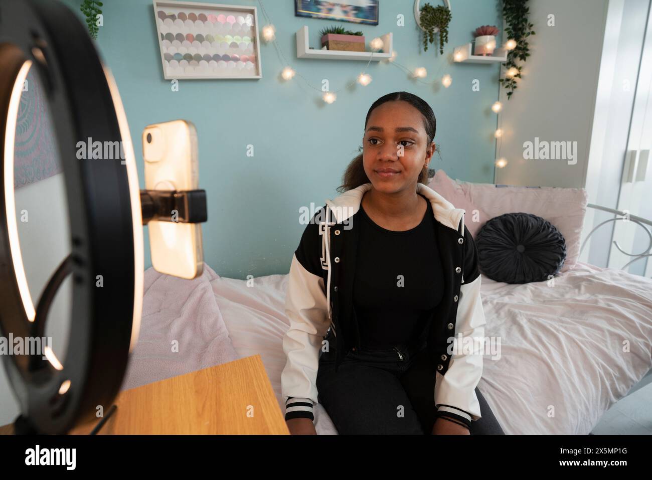 Girl filming video at home Stock Photo - Alamy