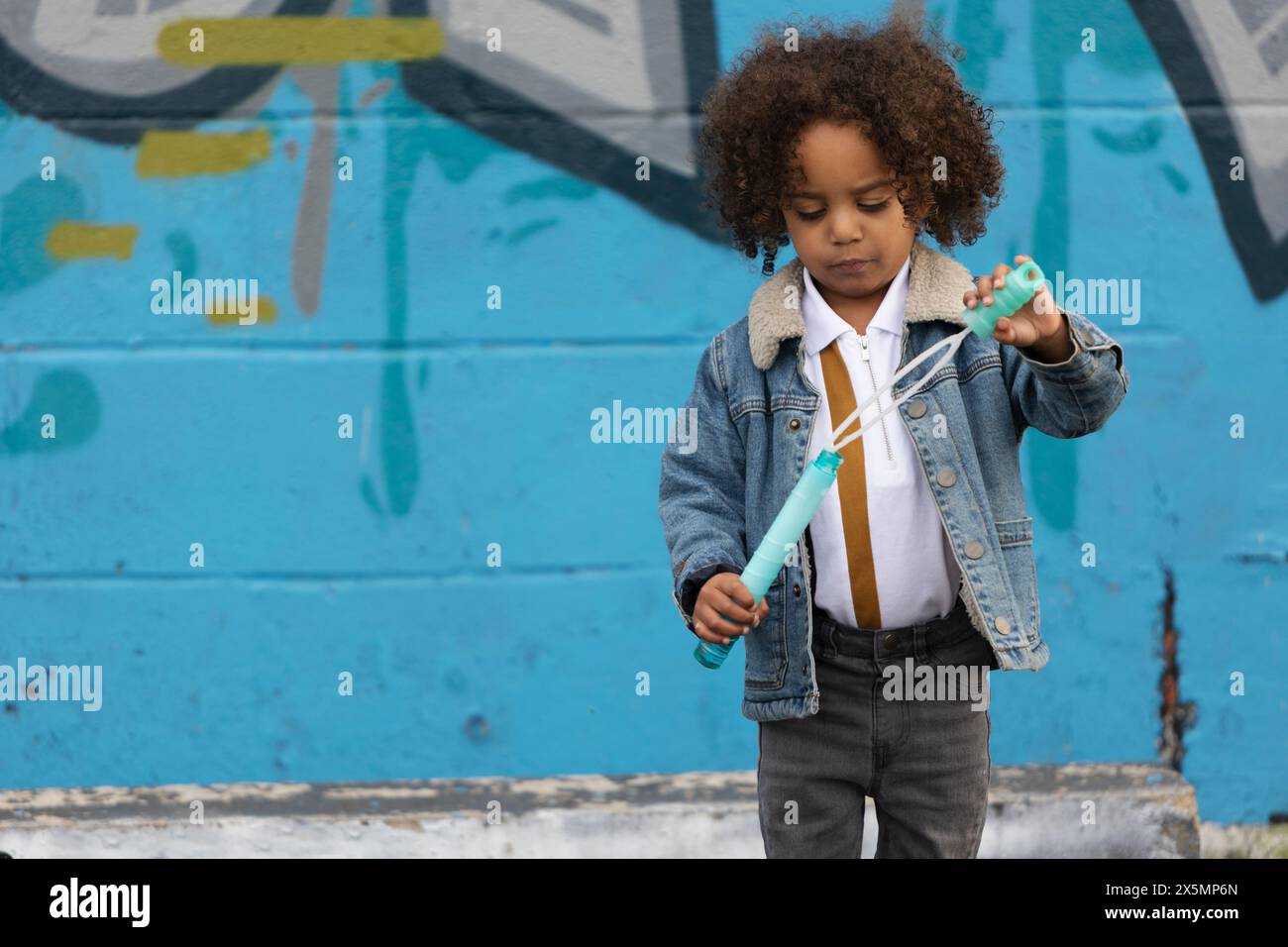 Boy against graffiti wall hi-res stock photography and images - Alamy