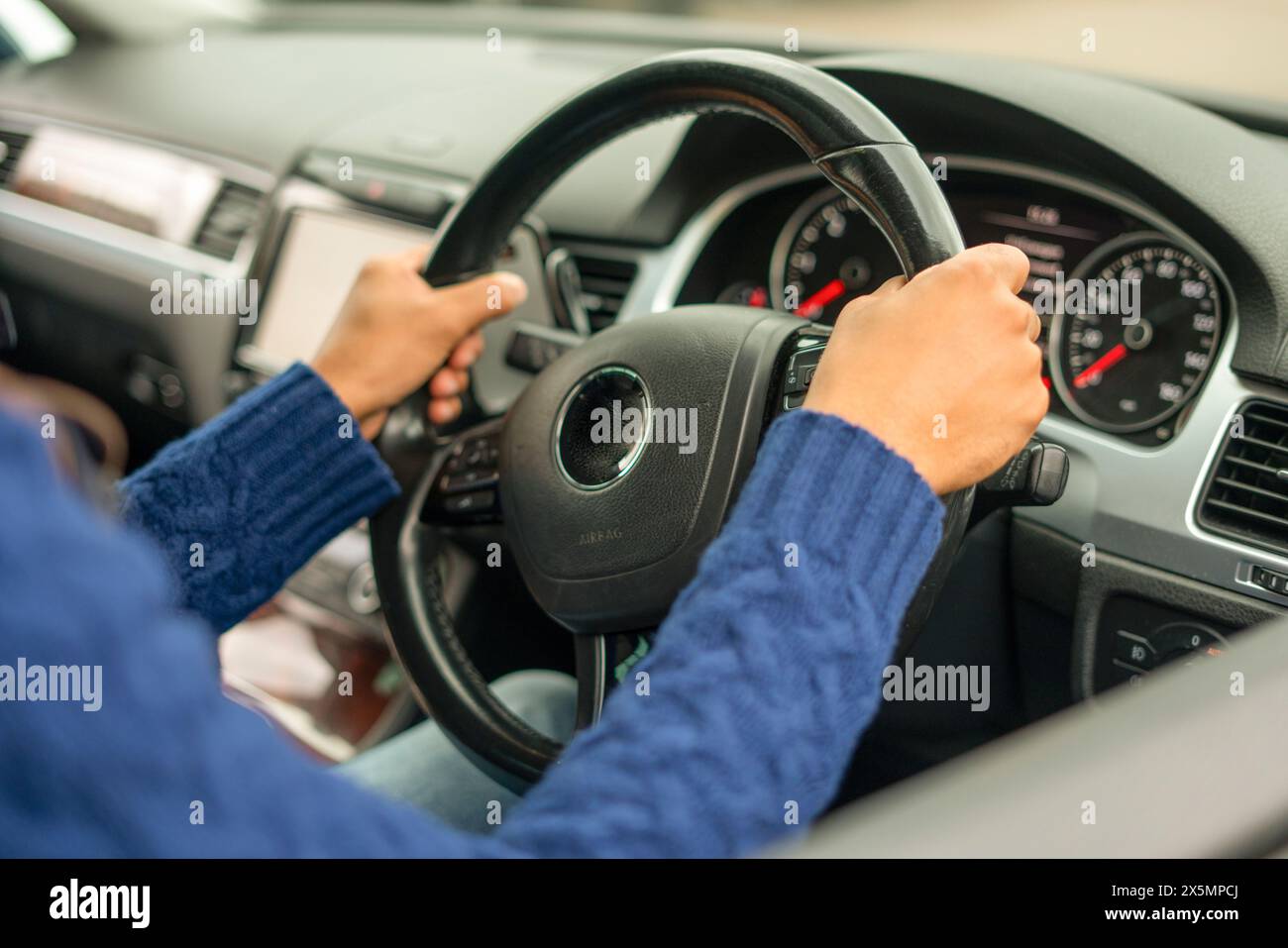 Mans hand on steering wheel hi-res stock photography and images - Alamy
