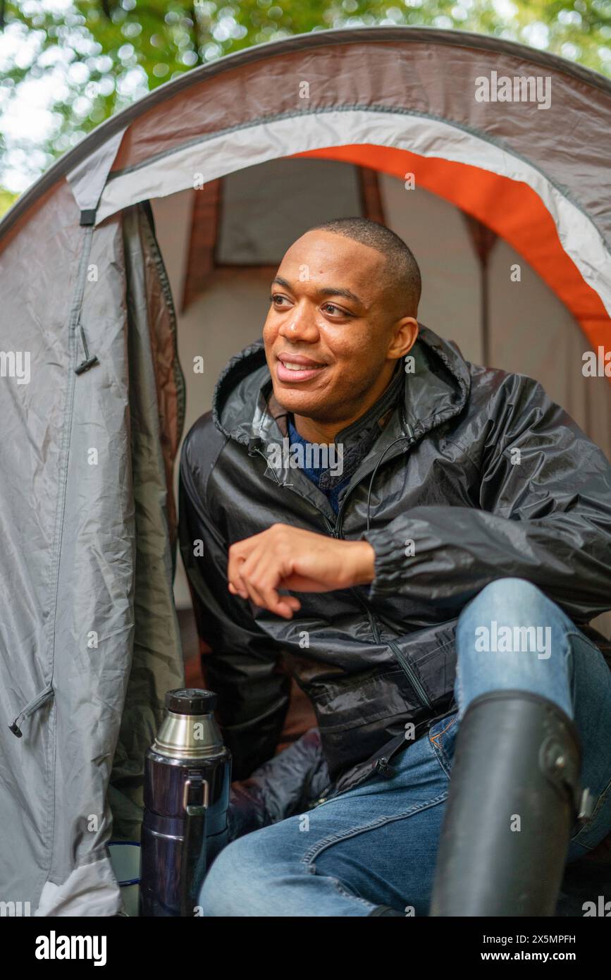 Man sitting in tent Stock Photo - Alamy