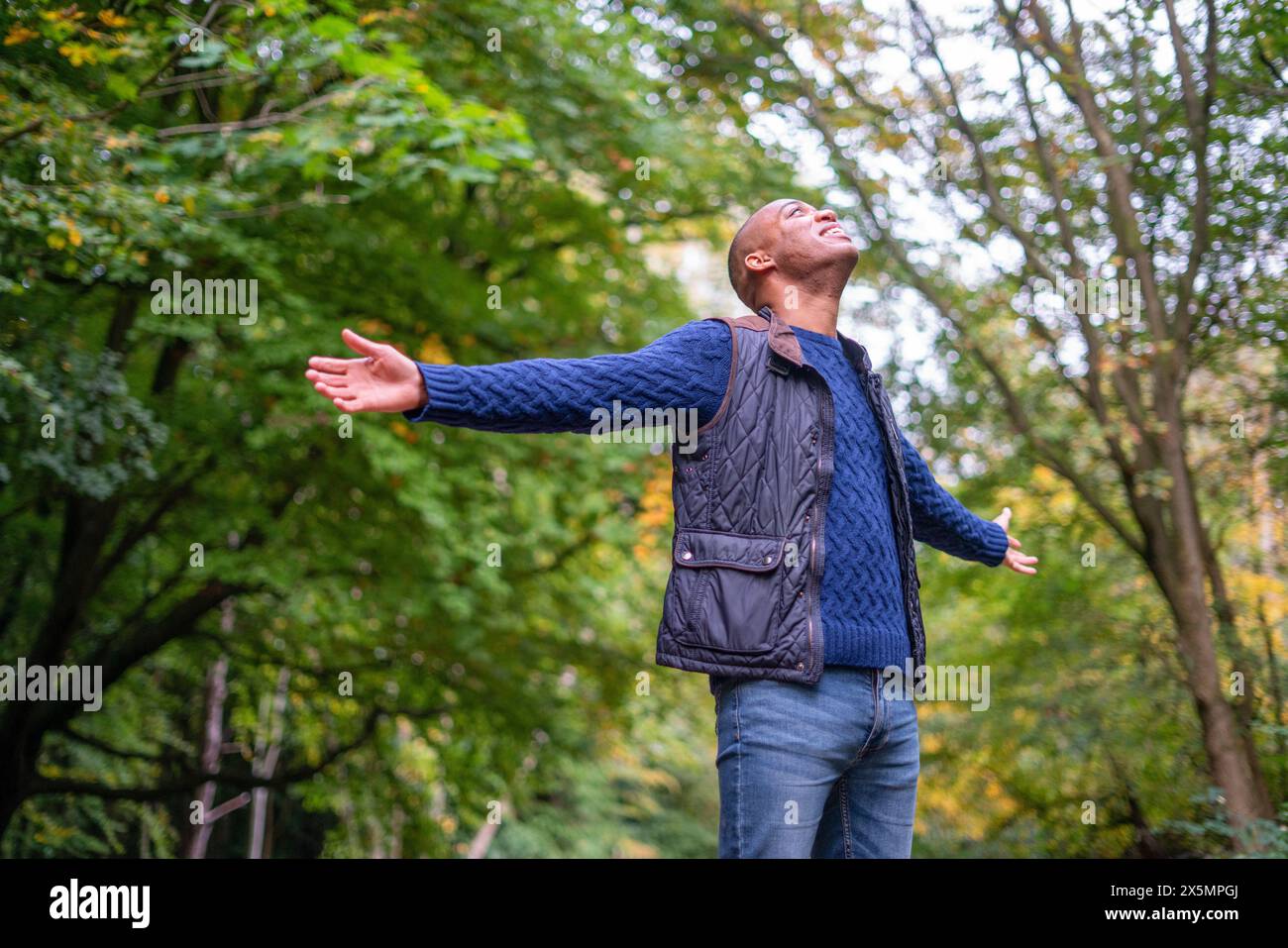 Man standing arms up hi-res stock photography and images - Alamy