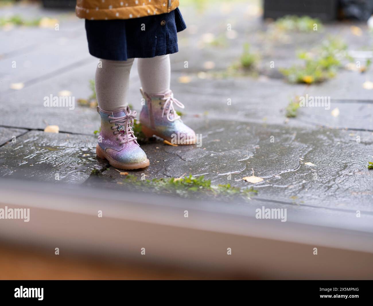 Girl standing in rain, low section Stock Photo - Alamy