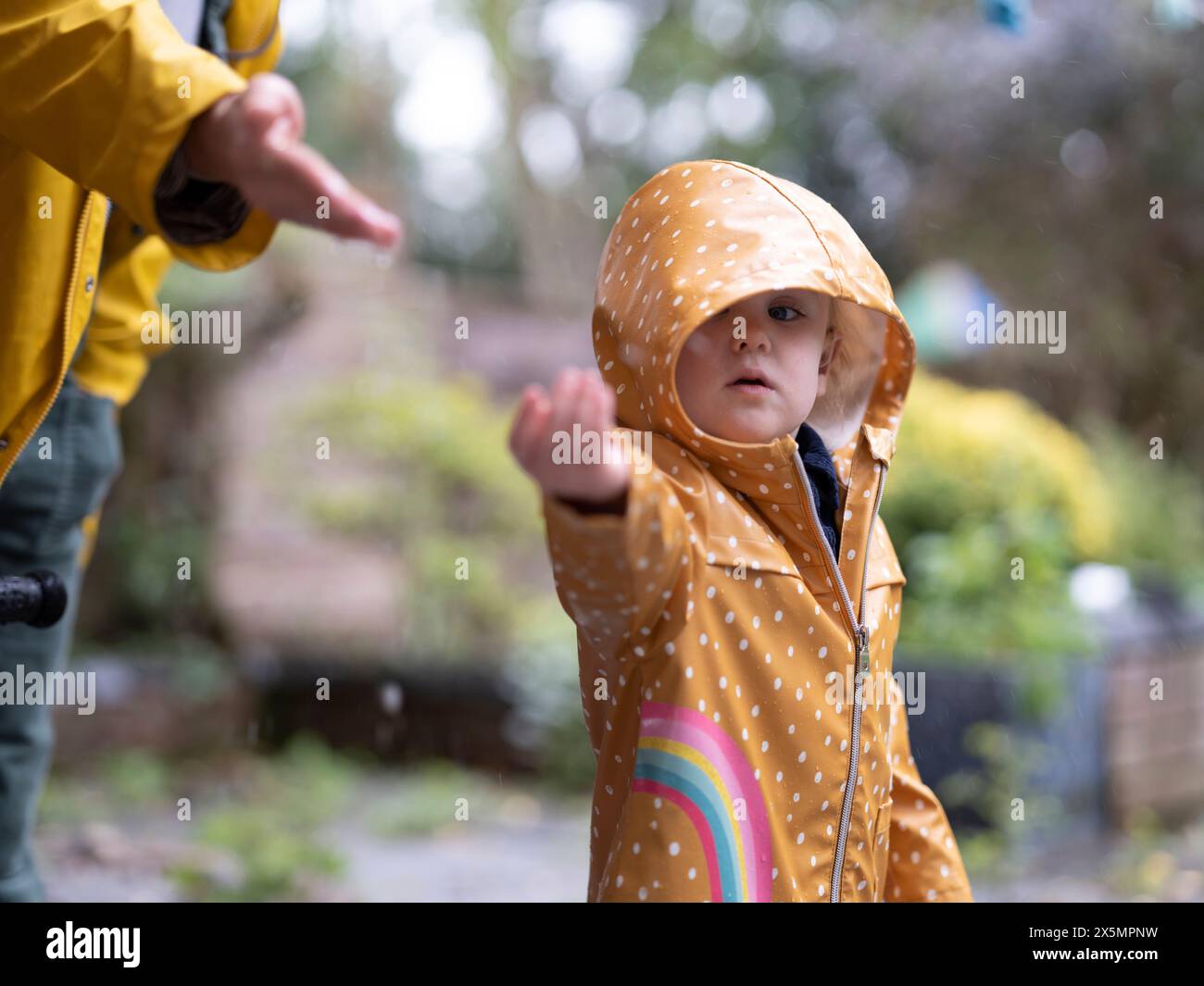 Mother and daughter catching rain drops Stock Photo - Alamy
