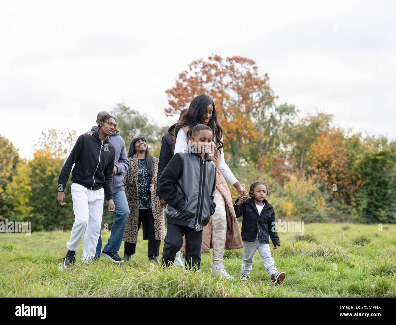 Multi-generational family walking in meadow Stock Photo - Alamy