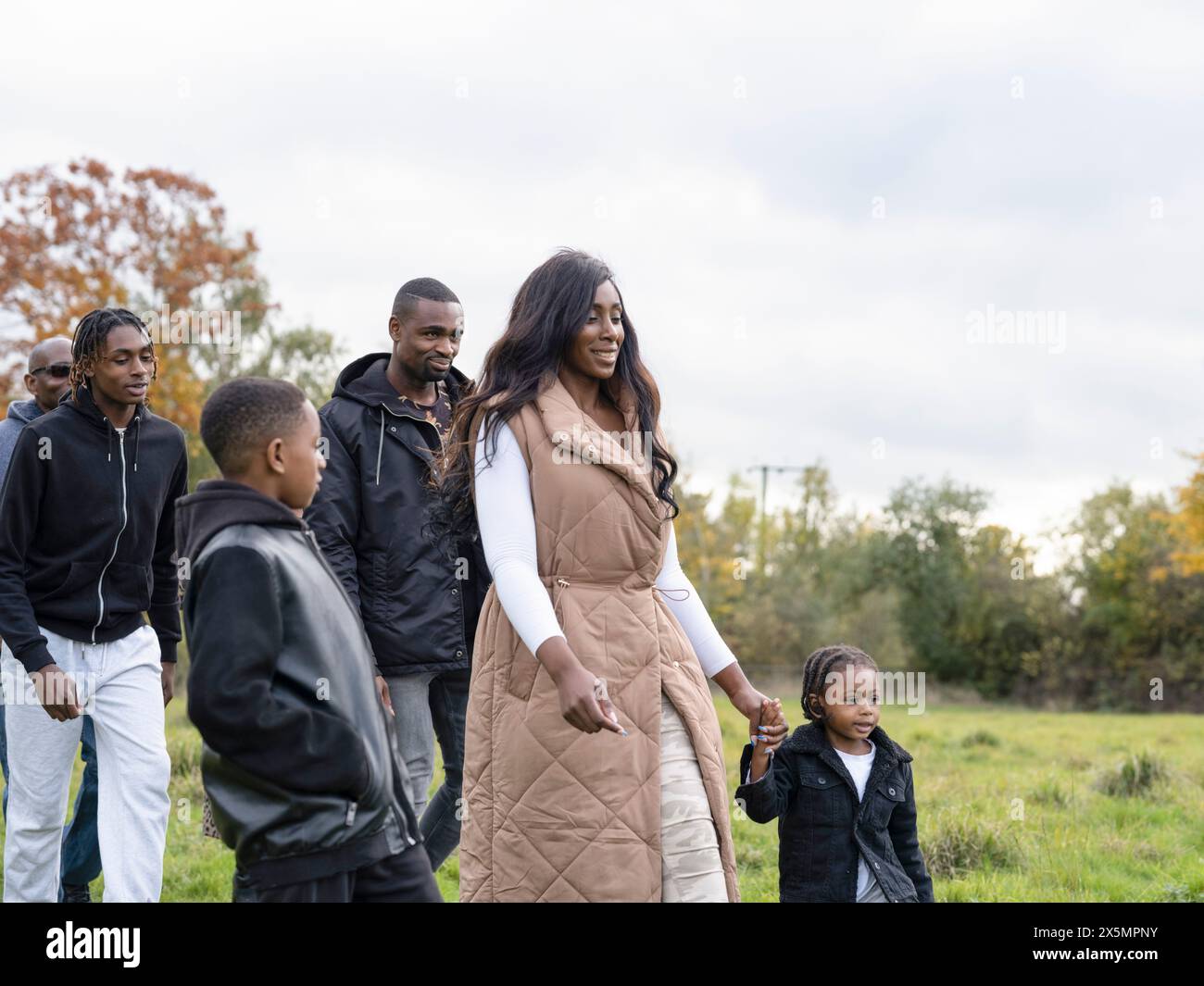 Multi-generational family walking in meadow Stock Photo - Alamy