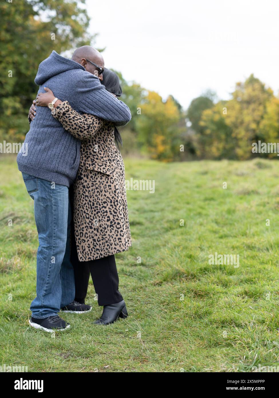 Couple embracing on meadow hi-res stock photography and images - Alamy
