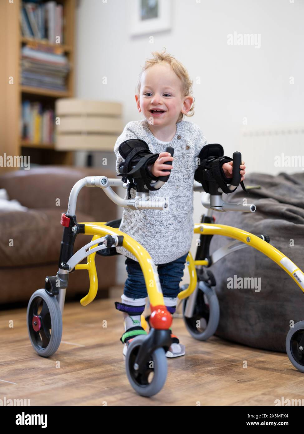 Boy with cerebral palsy walking with mobility walker Stock Photo - Alamy