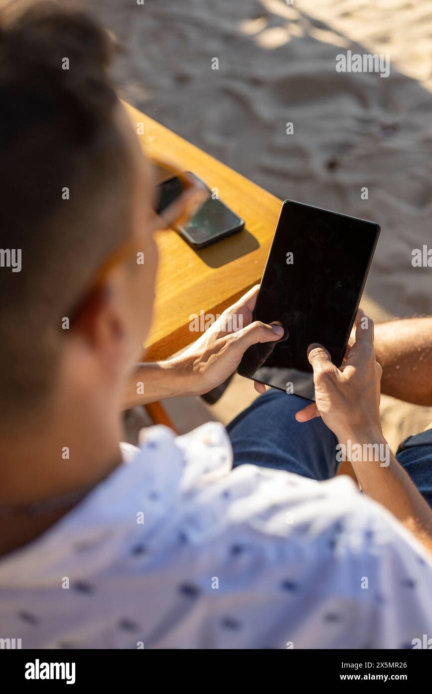 Man using smart phone on beach Stock Photo - Alamy
