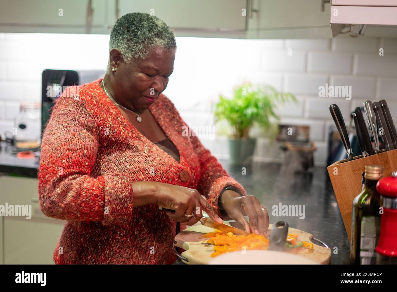 Woman senior cooking meal vegetable hi-res stock photography and images ...
