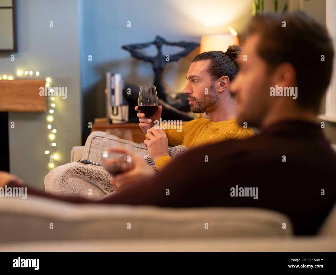 Guy couple watching television at home Stock Photo - Alamy