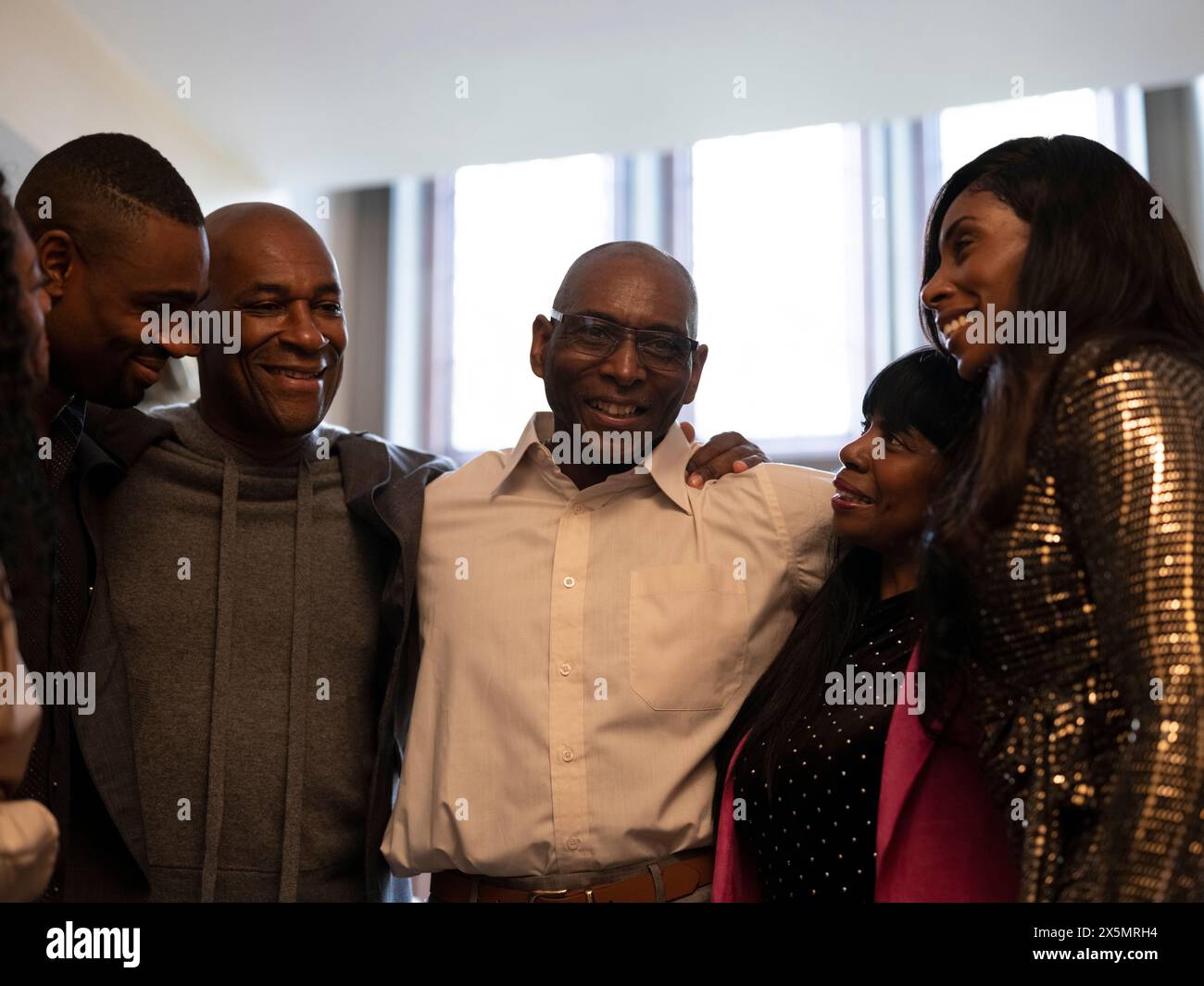 Smiling family embracing hi-res stock photography and images - Alamy