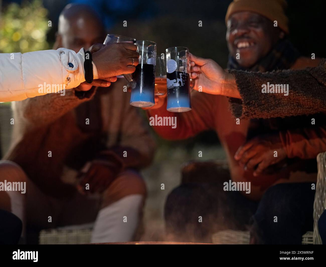 Family sitting on patio and raising toast Stock Photo - Alamy