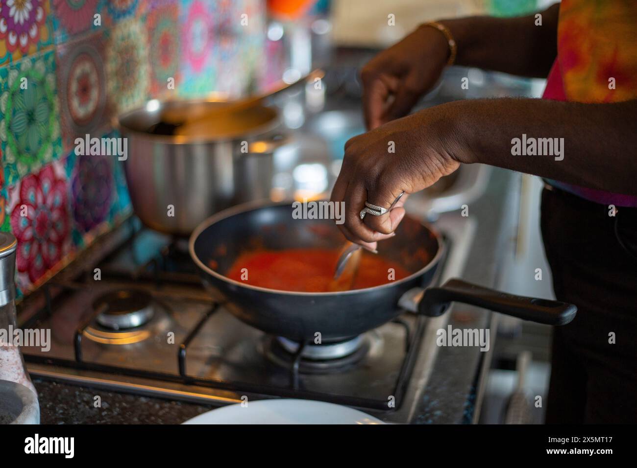Man cooking tomato sauce in pan Stock Photo - Alamy