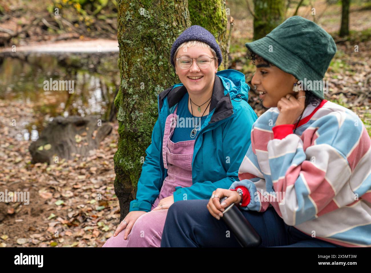 Two multiracial female friends talking hi-res stock photography and ...