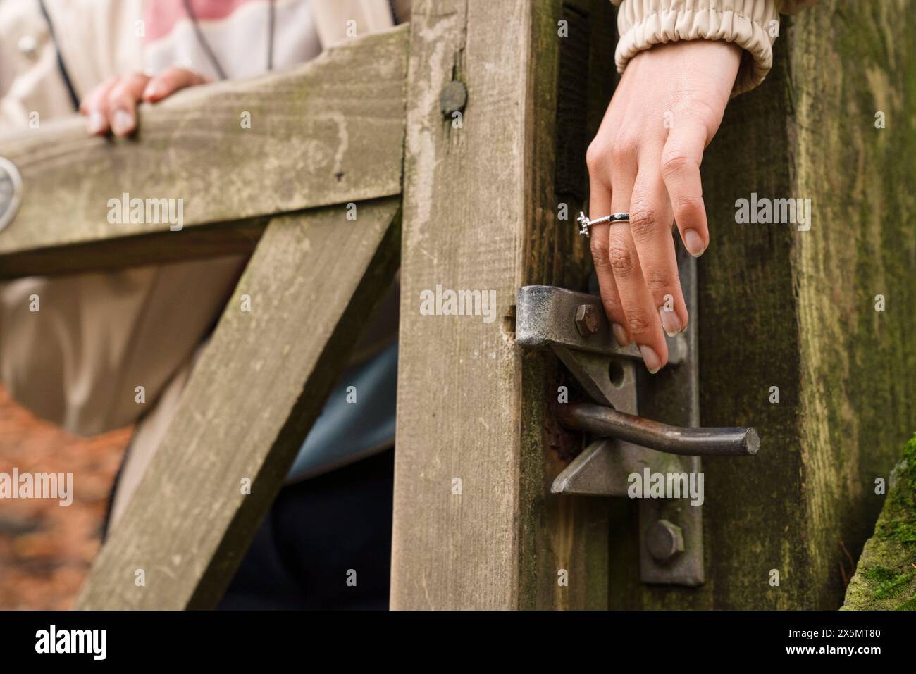 Young woman opening gate hi-res stock photography and images - Alamy