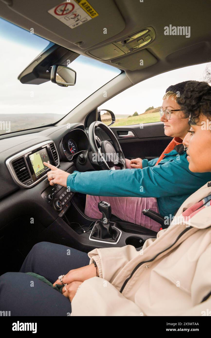 Female friends using gps hi-res stock photography and images - Alamy