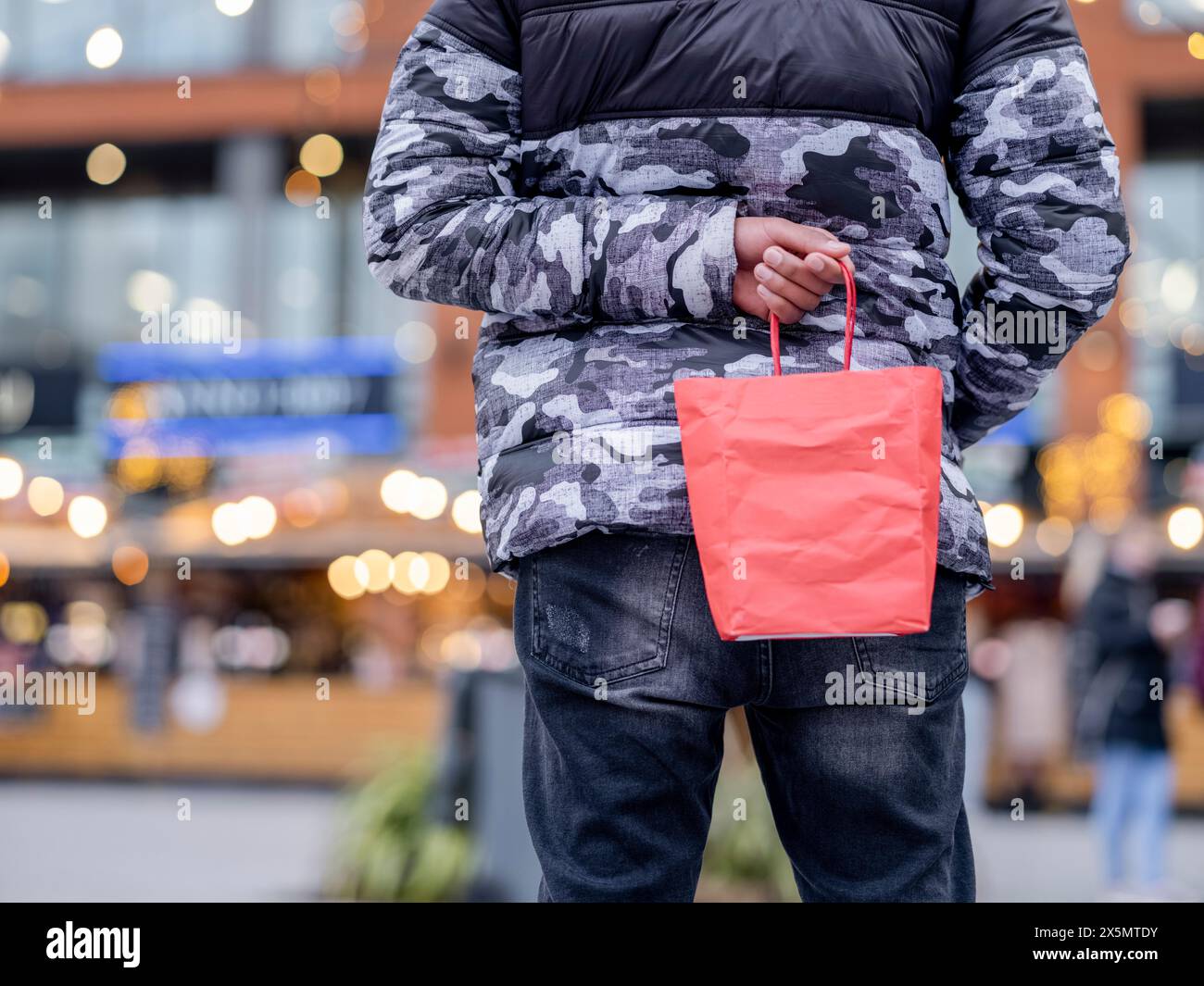 Holding bag behind back hi-res stock photography and images - Alamy