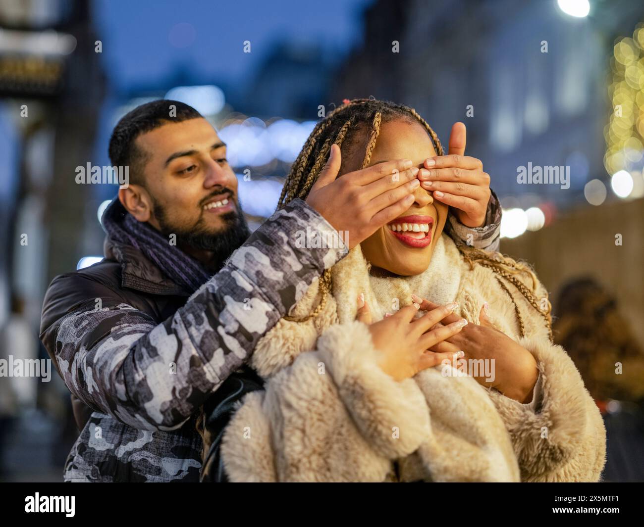 Boyfriend covering girlfriends eyes for surprise Stock Photo - Alamy