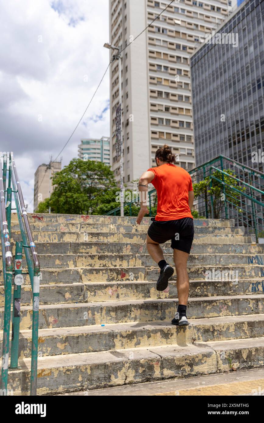 Brazil, Sao Paulo, Rear view of man exercising on steps in city Stock ...