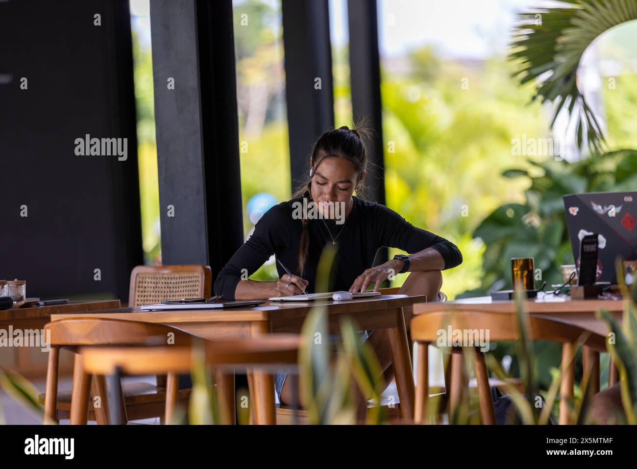 Woman sitting in hotel lounge and writing Stock Photo - Alamy