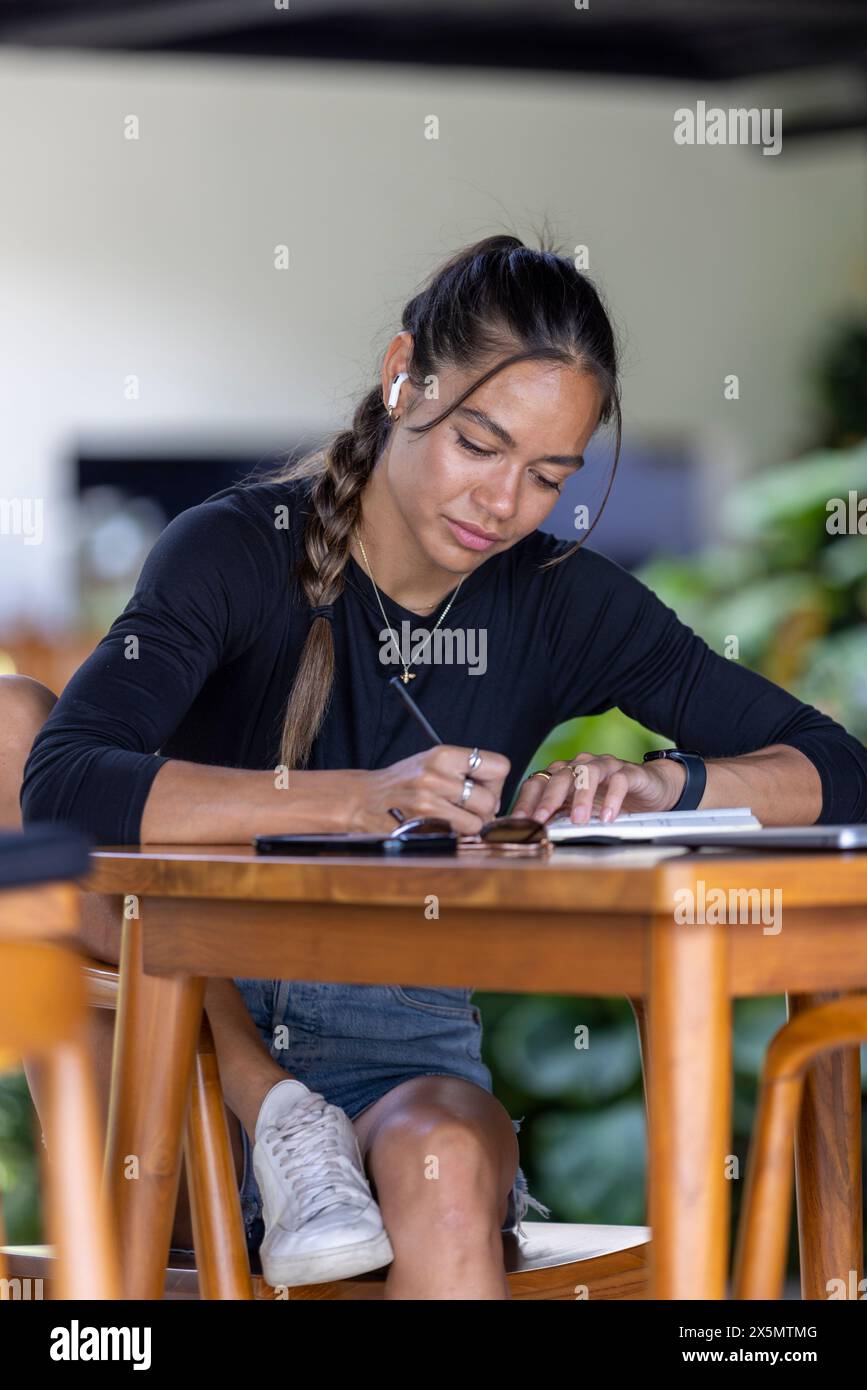 Woman sitting in hotel lounge and writing Stock Photo - Alamy
