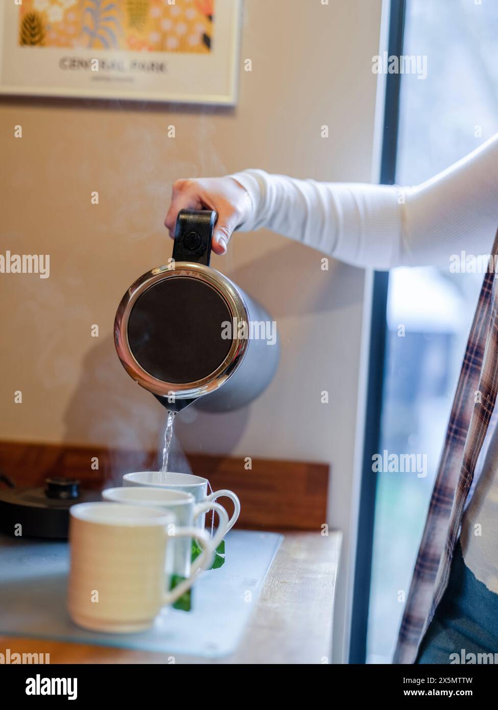 Woman pouring water cup hi-res stock photography and images - Alamy
