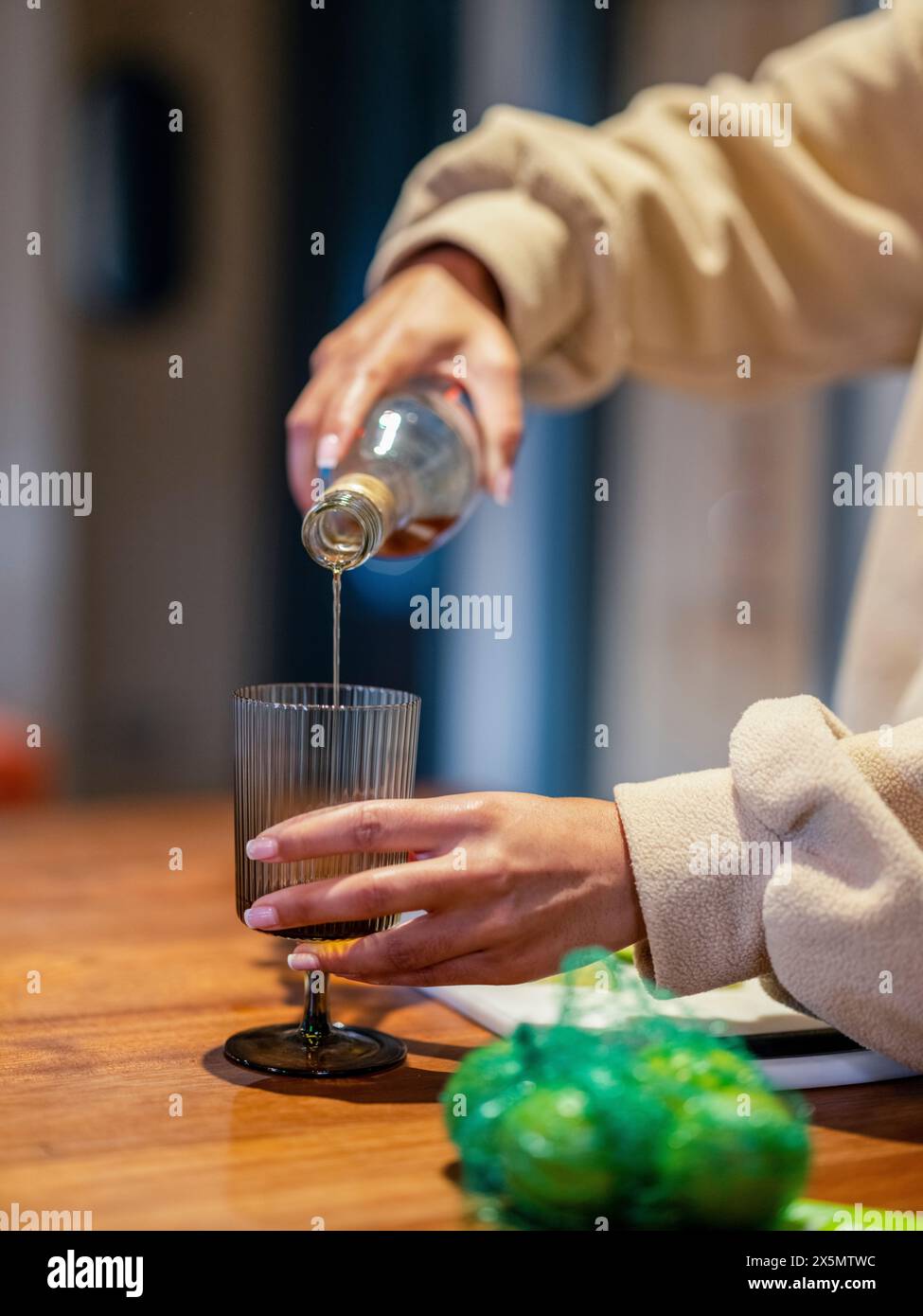 Woman preparing alcoholic cocktails in kitchen Stock Photo - Alamy