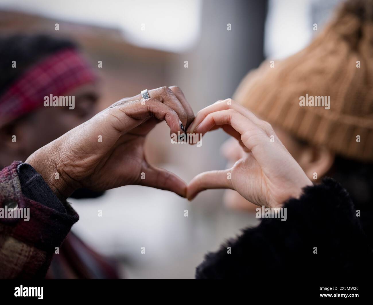 Close-up of couple making heart hand sign Stock Photo - Alamy