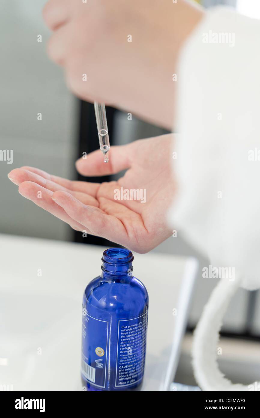 Woman applying retinol serum drop hi-res stock photography and images ...