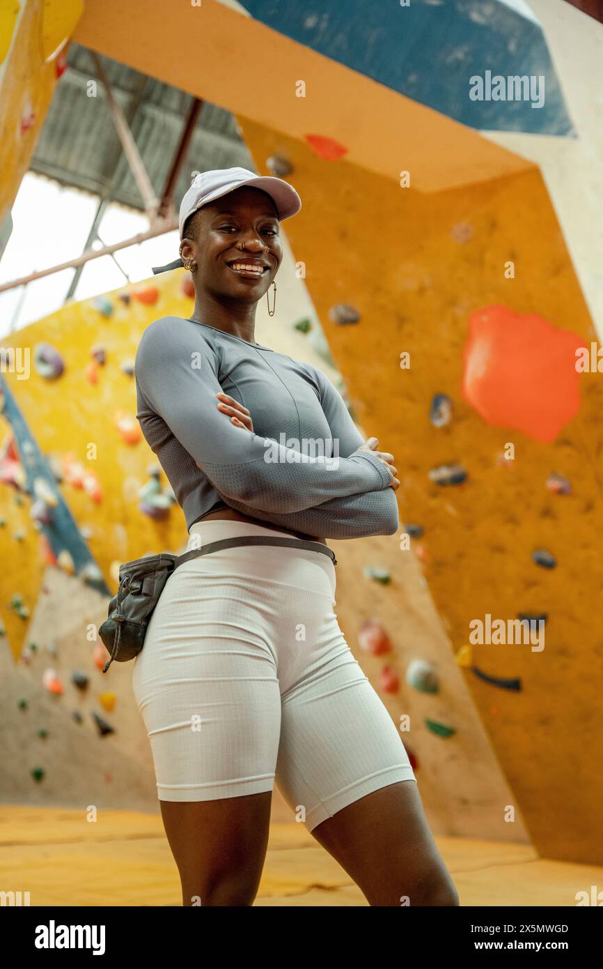 Portrait of smiling woman in front of climbing wall Stock Photo - Alamy