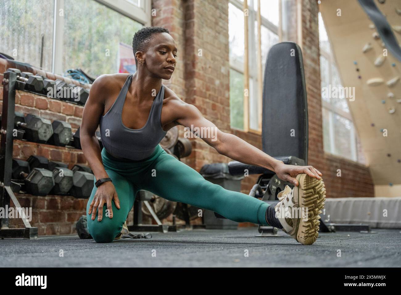 Athletic woman stretching at gym Stock Photo - Alamy