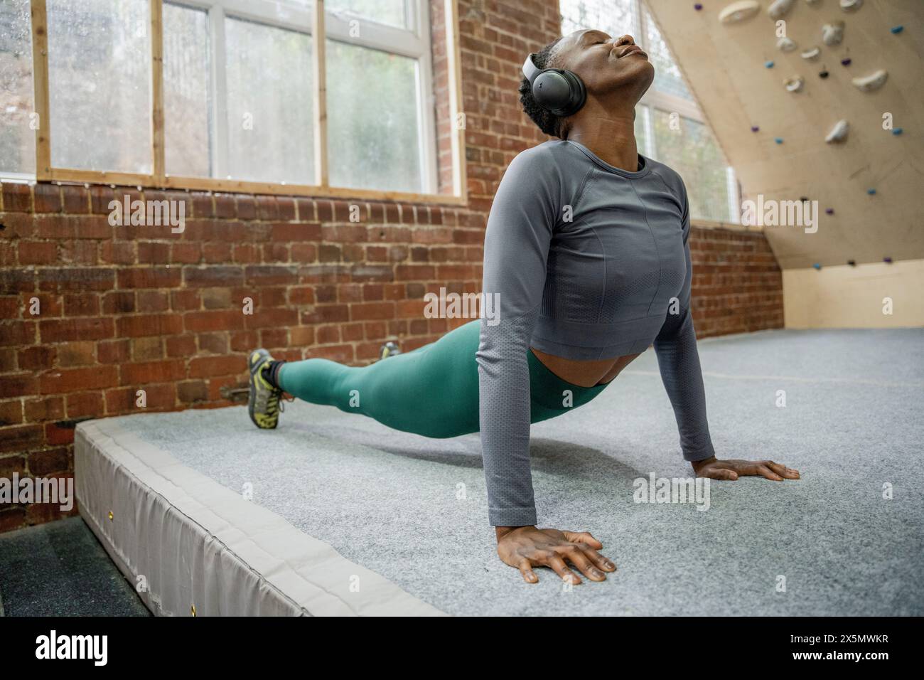 Athletic woman stretching at gym Stock Photo - Alamy