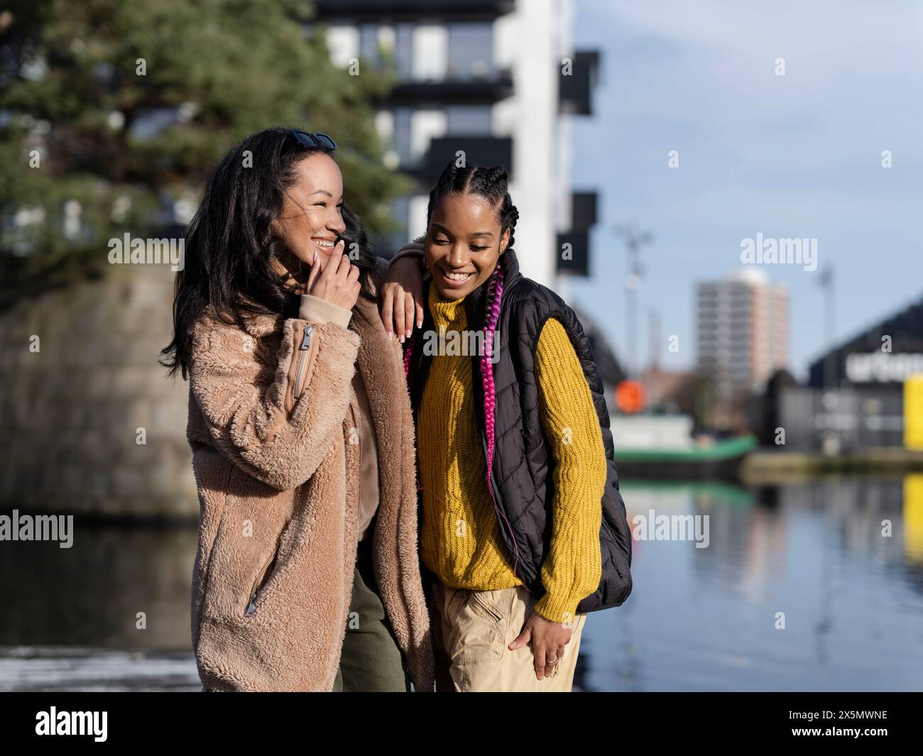 Two young women in urban setting Stock Photo - Alamy