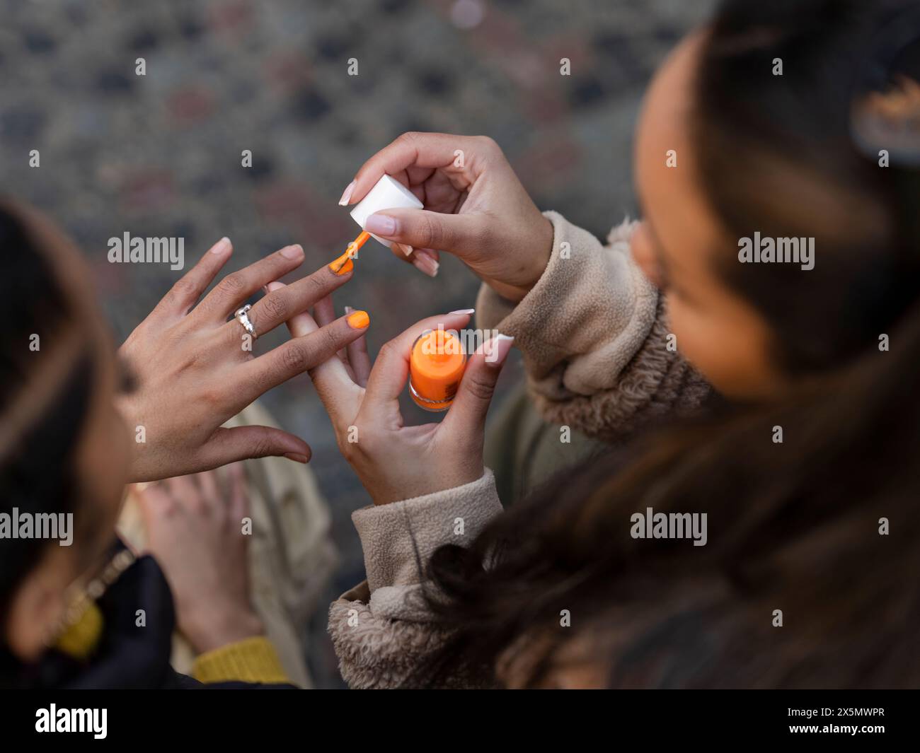 Two young women painting nails together Stock Photo - Alamy