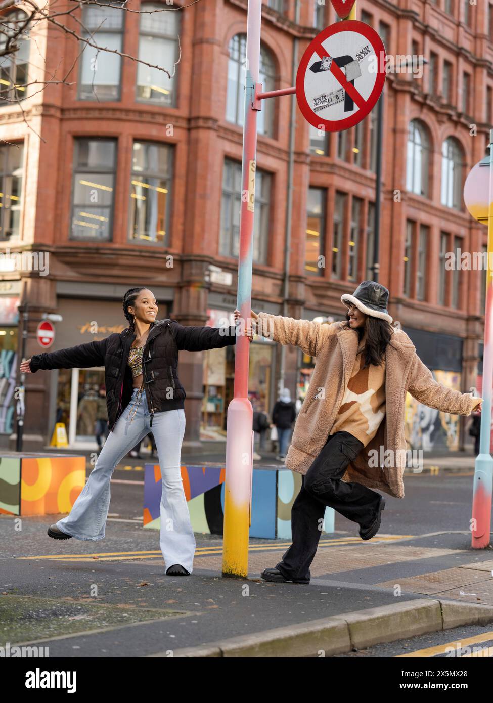Two young women dancing in street Stock Photo - Alamy