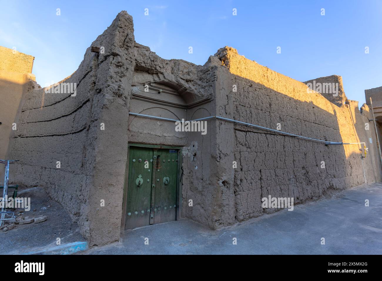 Traditional adobe building with exquisite and unique wooden doors. It ...
