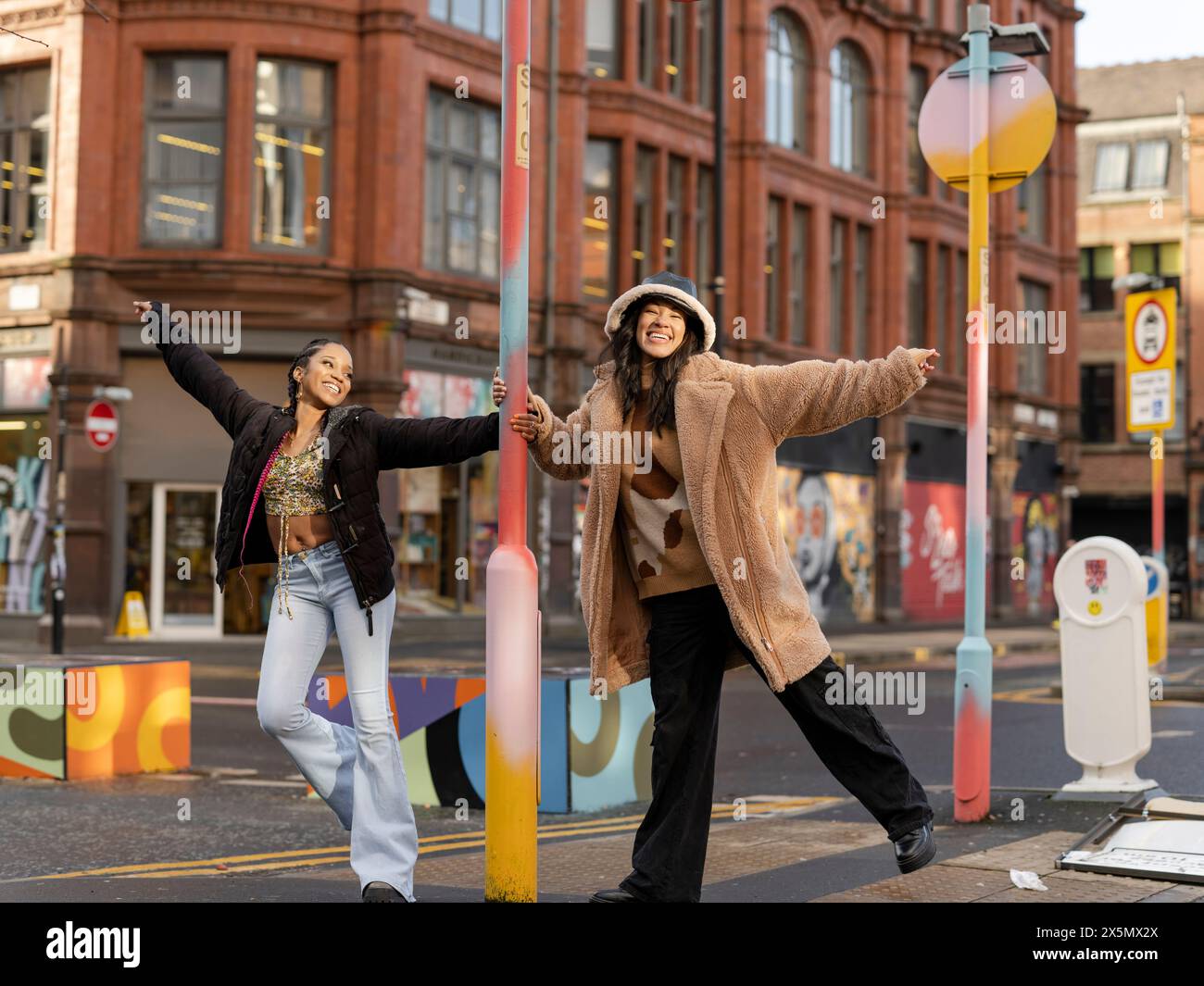 Two young women dancing in street Stock Photo - Alamy